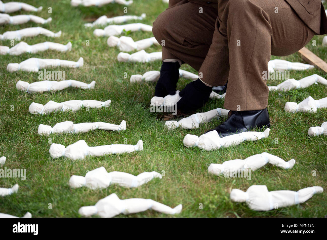 A soldiers from the 5 Rifles Battalion places one of 1,561 shrouded ...