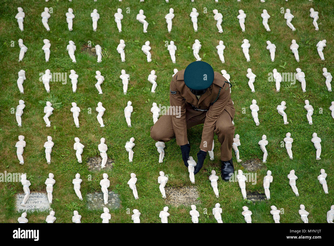 A soldiers from the 5 Rifles Battalion places one of 1,561 shrouded ...