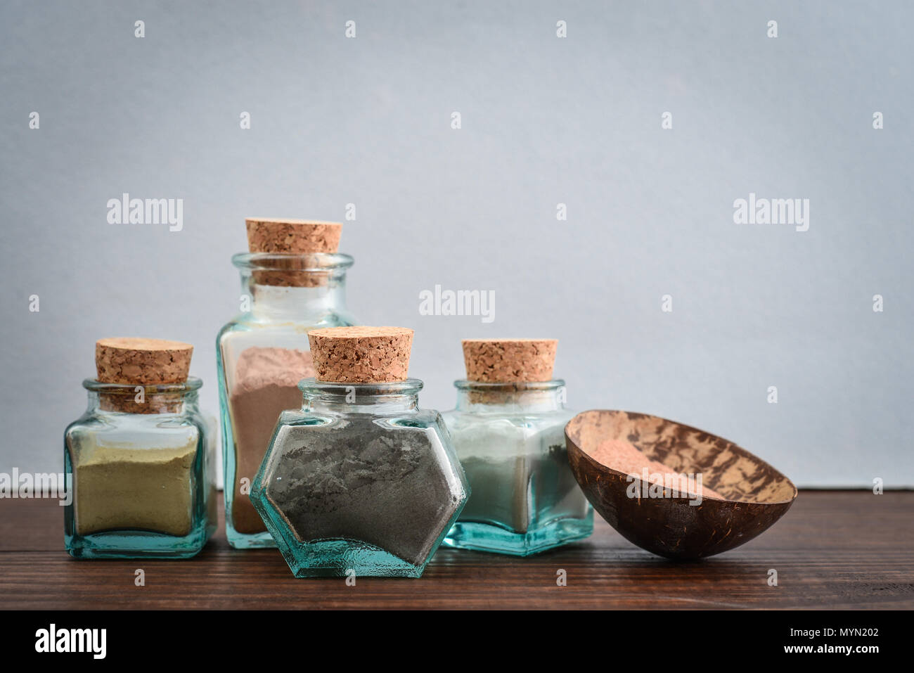 Different cosmetic clay in vintage jars on blue background Stock Photo ...