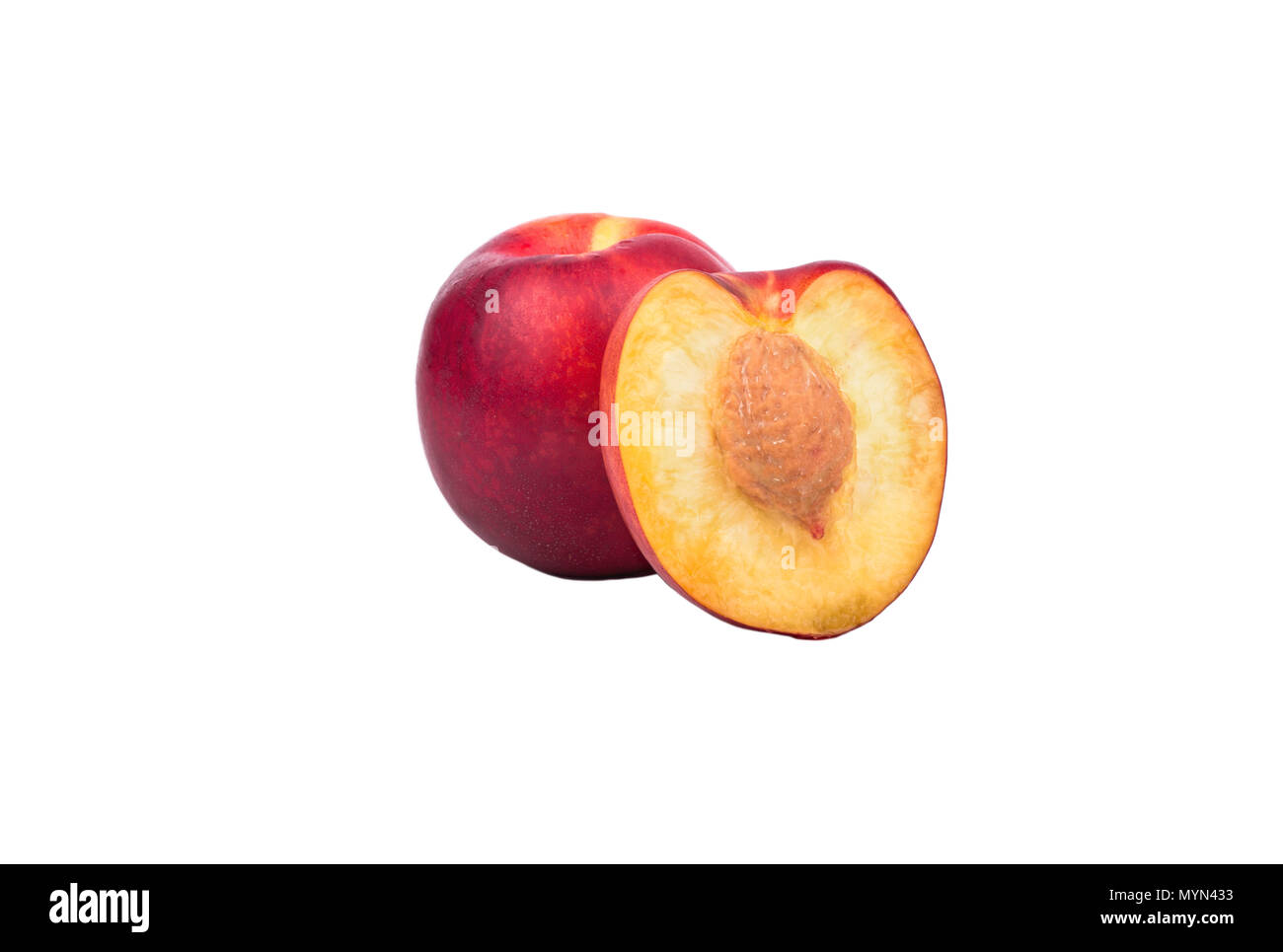 Fresh fruit nectarines with half on a white background Stock Photo - Alamy