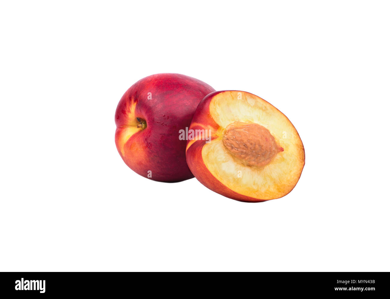 Fresh fruit nectarines with half on a white background Stock Photo - Alamy