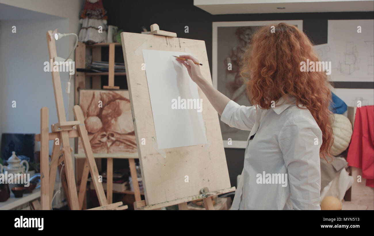 Female student working on a new painting in art class Stock Photo - Alamy