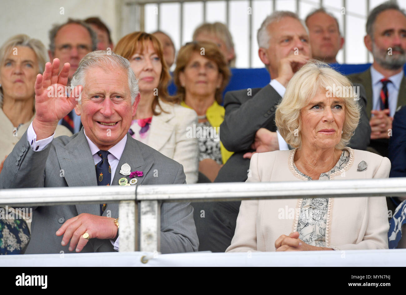 The Prince of Wales and the Duchess of Cornwall watch a parade during a ...