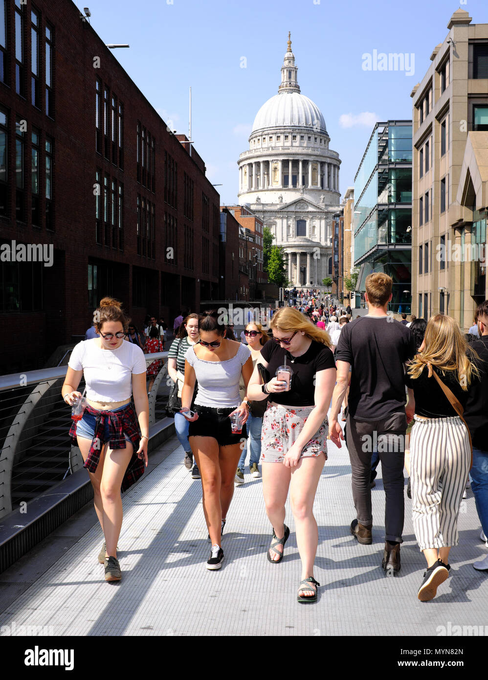 Girls comparing tans on Millennium Bridge, London, England, UK Stock ...