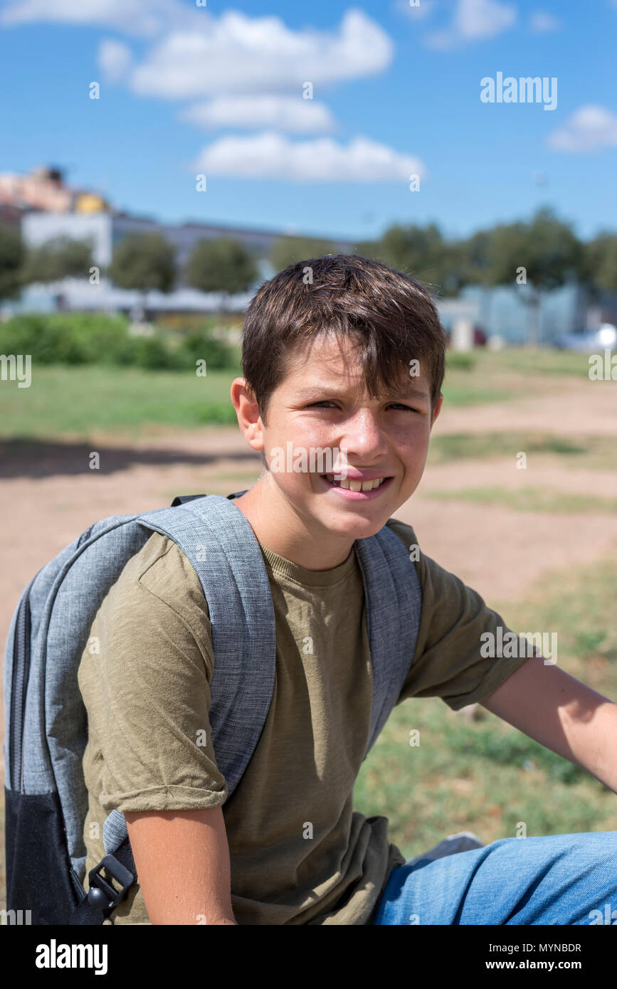 Cheerful child carrying his backpack Stock Photo - Alamy