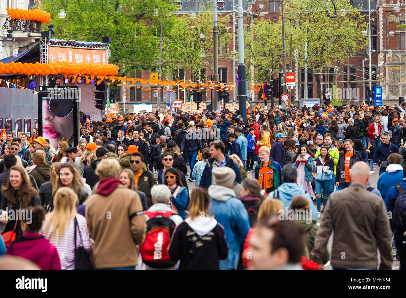 Crowd of people on the street celebrate King's day in Amsterdam city ...
