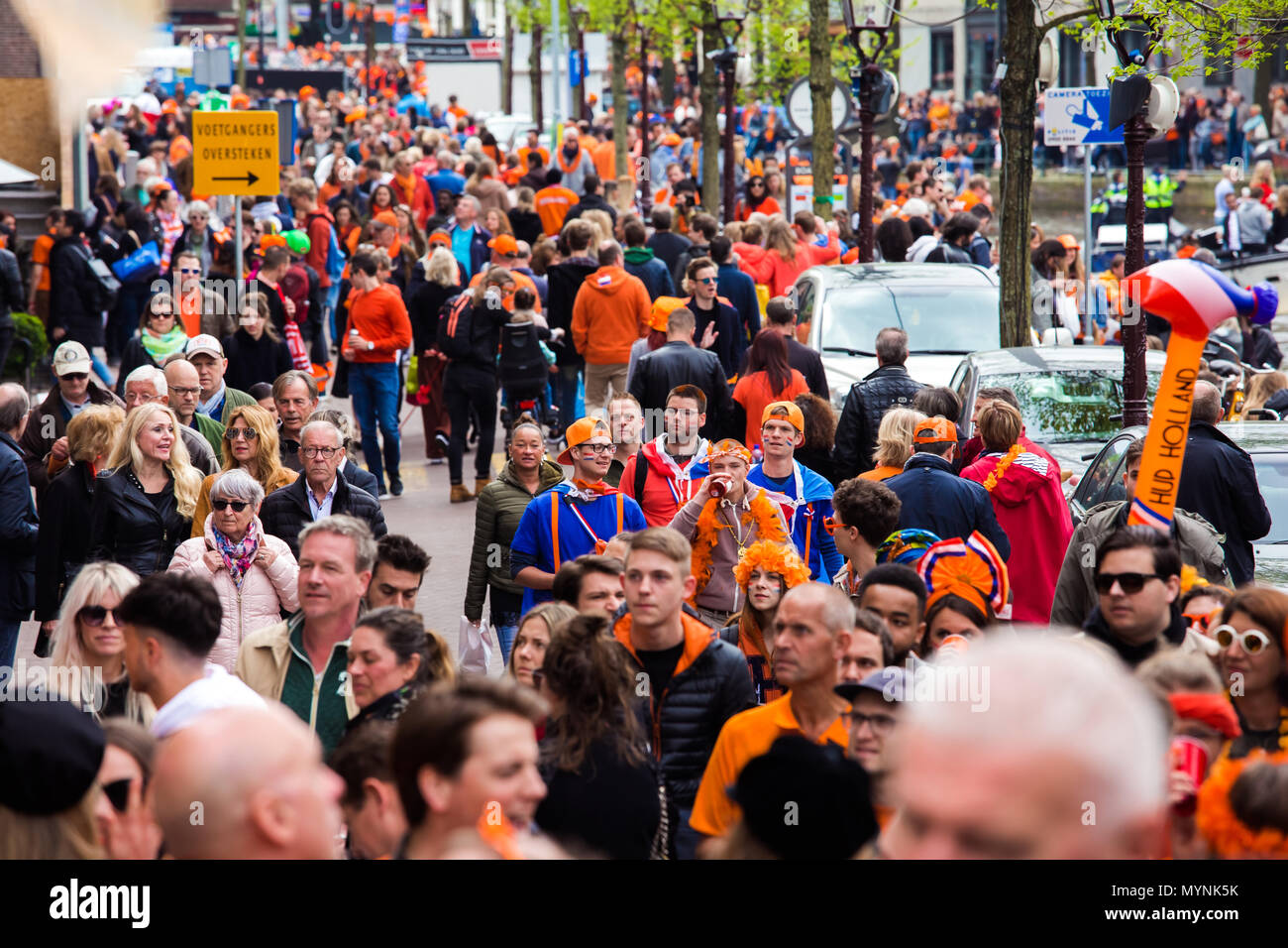 Crowd of people on the street celebrate King's day in Amsterdam city ...