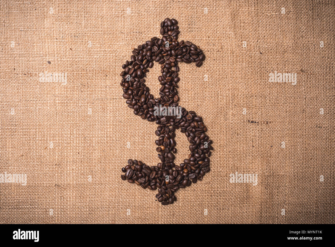 Dollar symbol written with toasted coffee beans on landscape ...