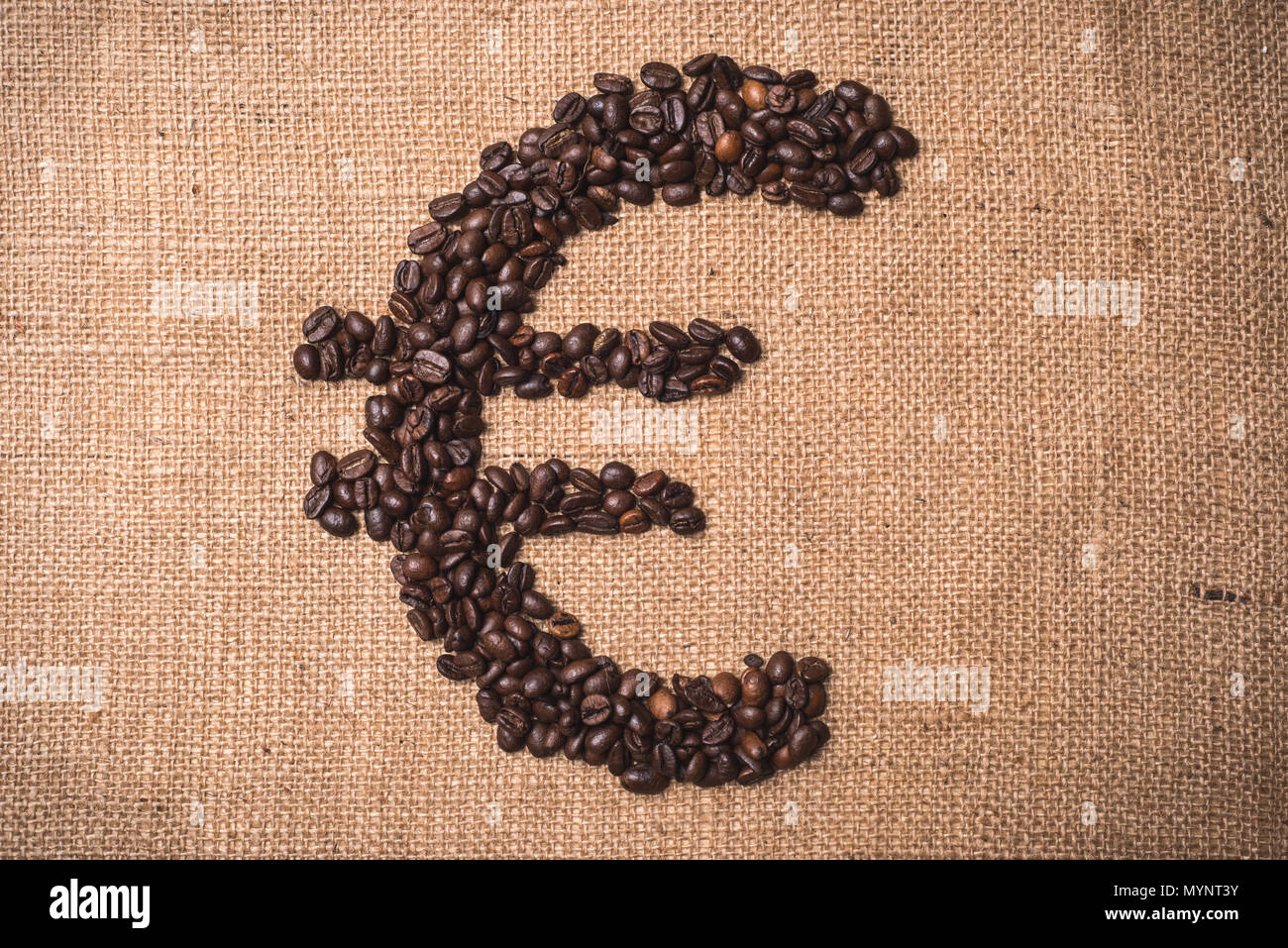 Euro symbol written with toasted coffee beans on landscape composition ...