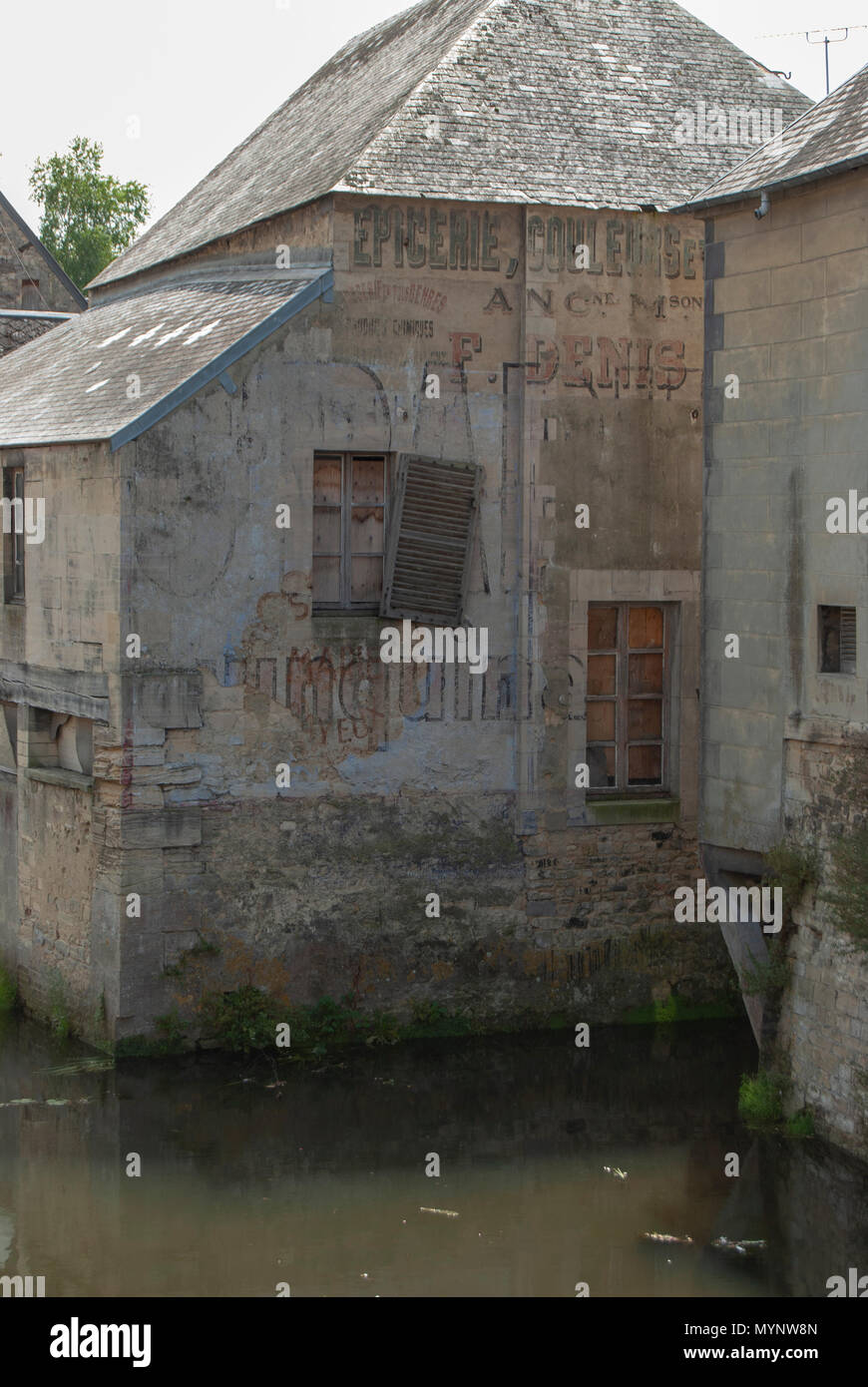 Old French building with remains of painted advert reminiscint of WW2 ...