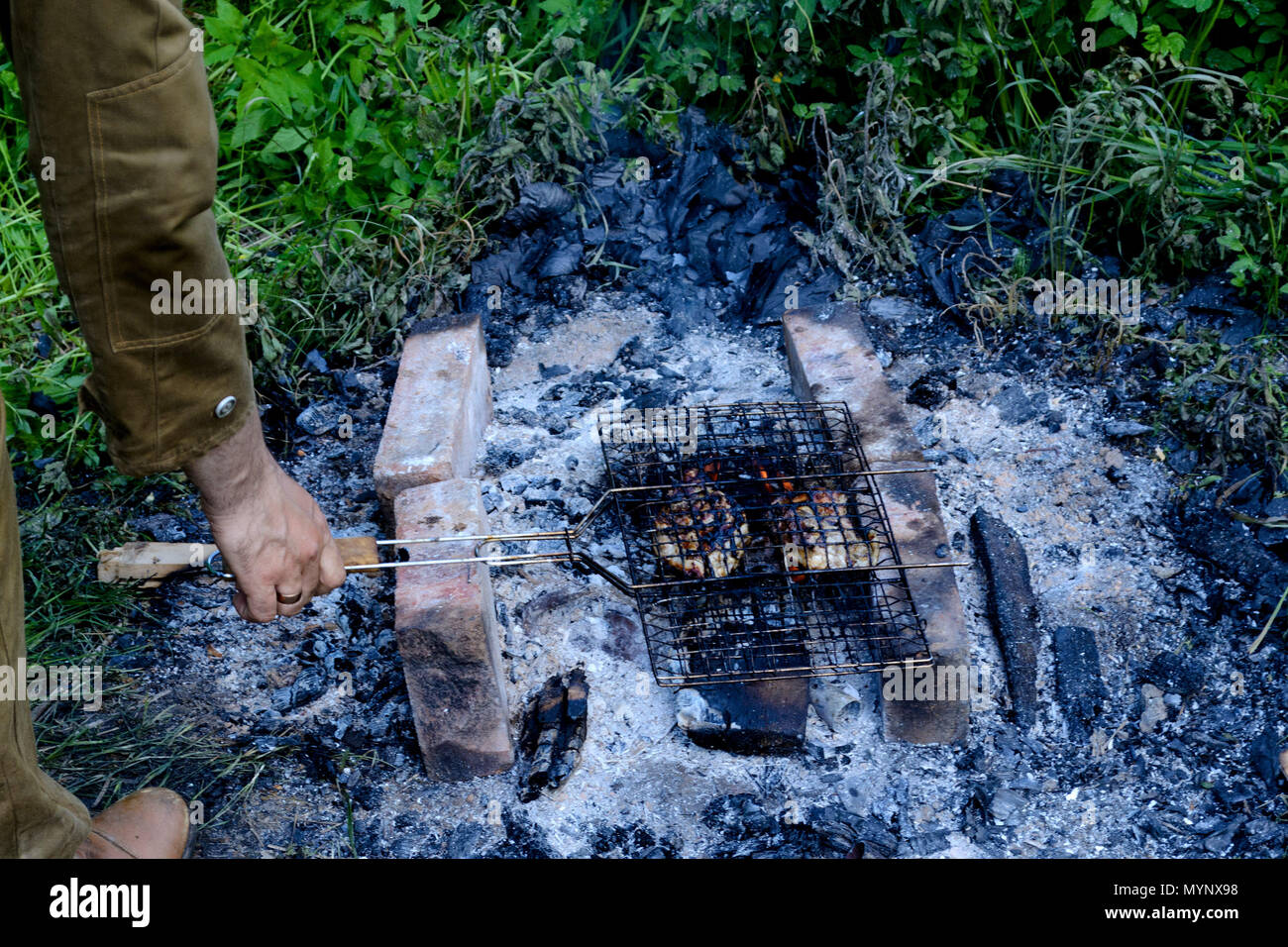 Man charcoal grilling chicken hi-res stock photography and images - Alamy