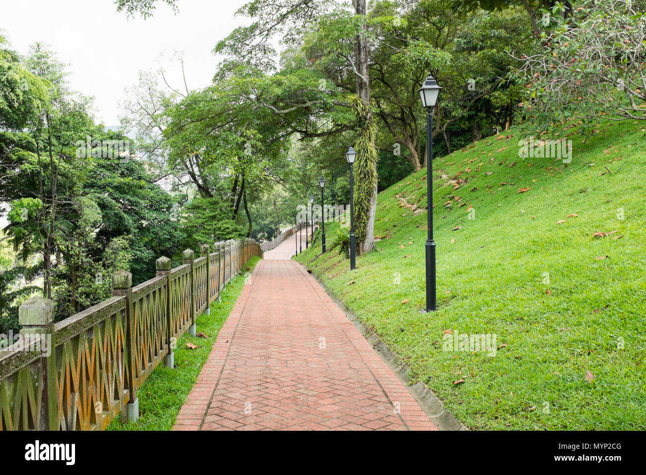 Red brick footpath along the edge of Fort Canning Park in Singapore ...