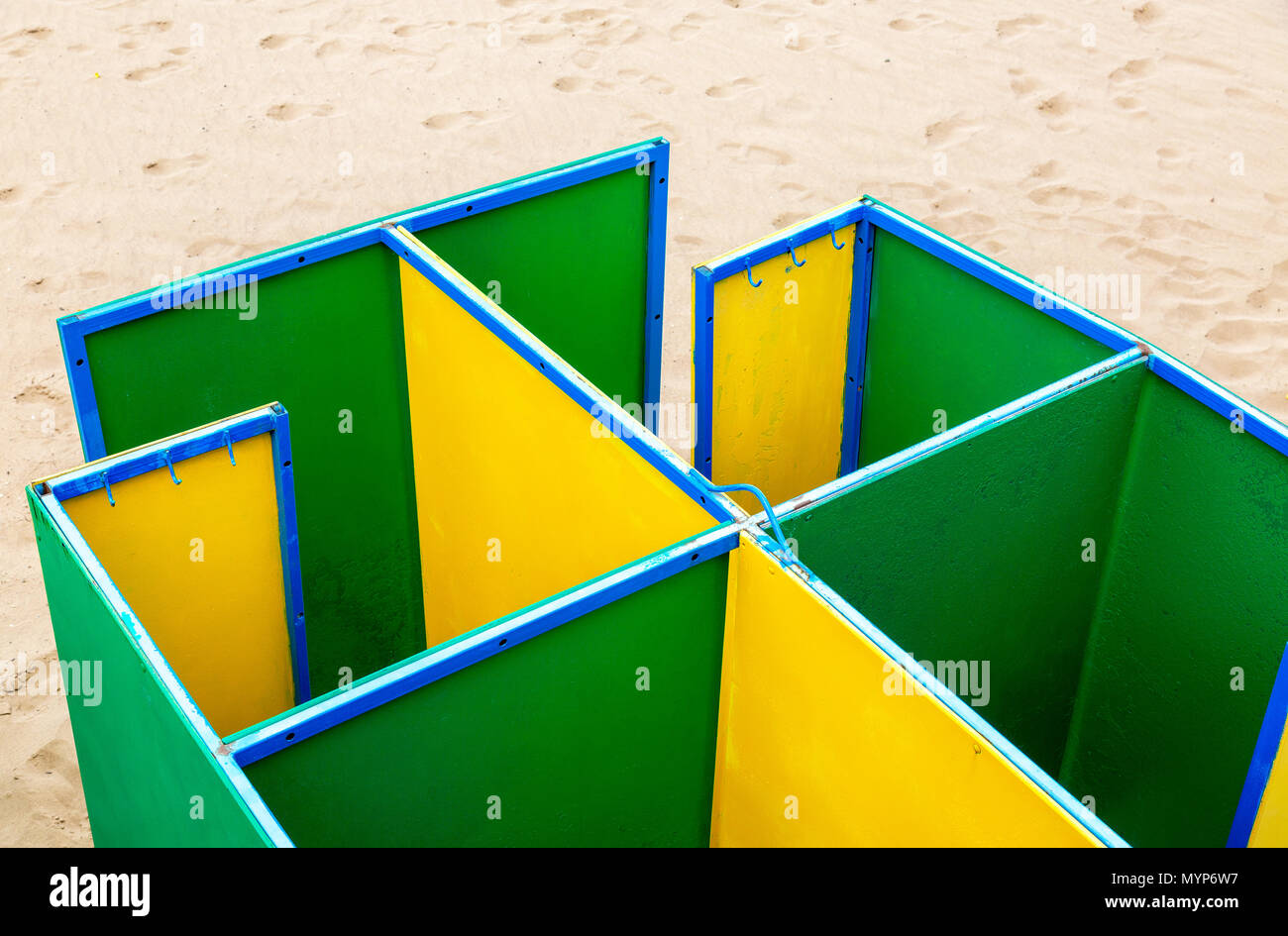 Multicolored beach changing rooms at the sandy beach. Cabins dressing ...
