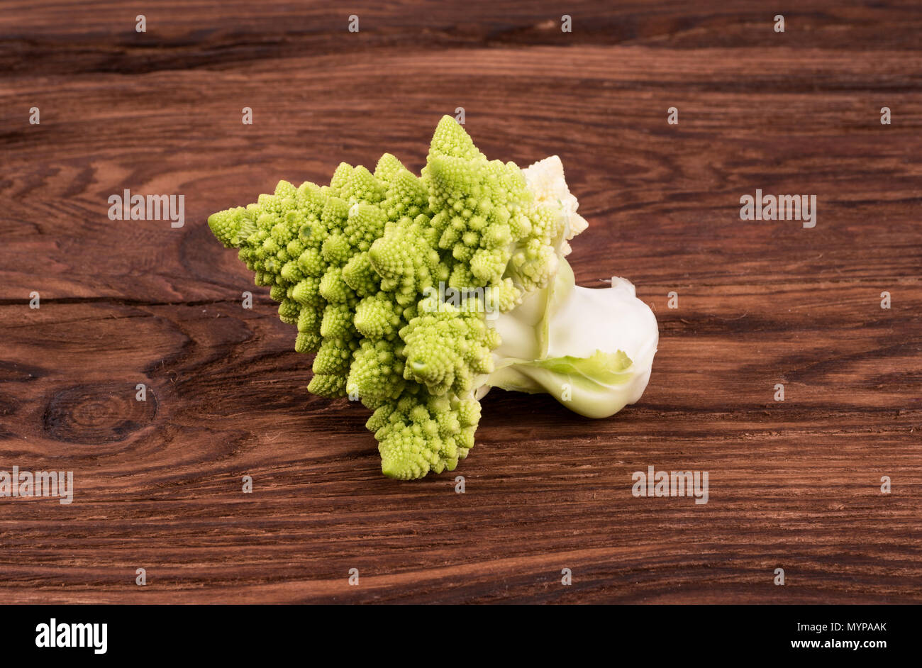 Sprig of fresh green cabbage Romanesco on a wooden background Stock ...