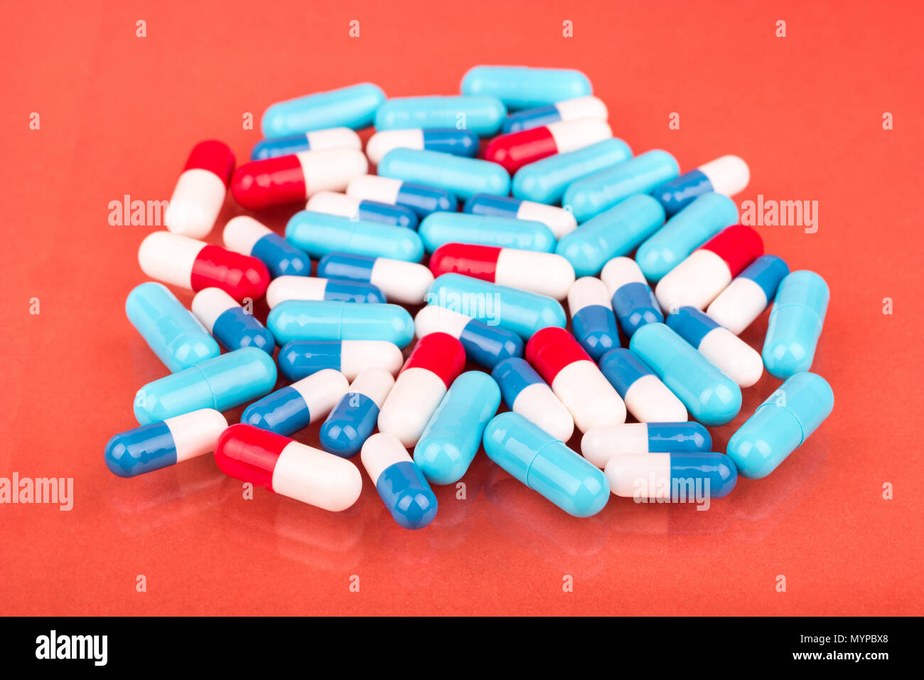 Big pile of multi-colored capsules on a peach background Stock Photo ...