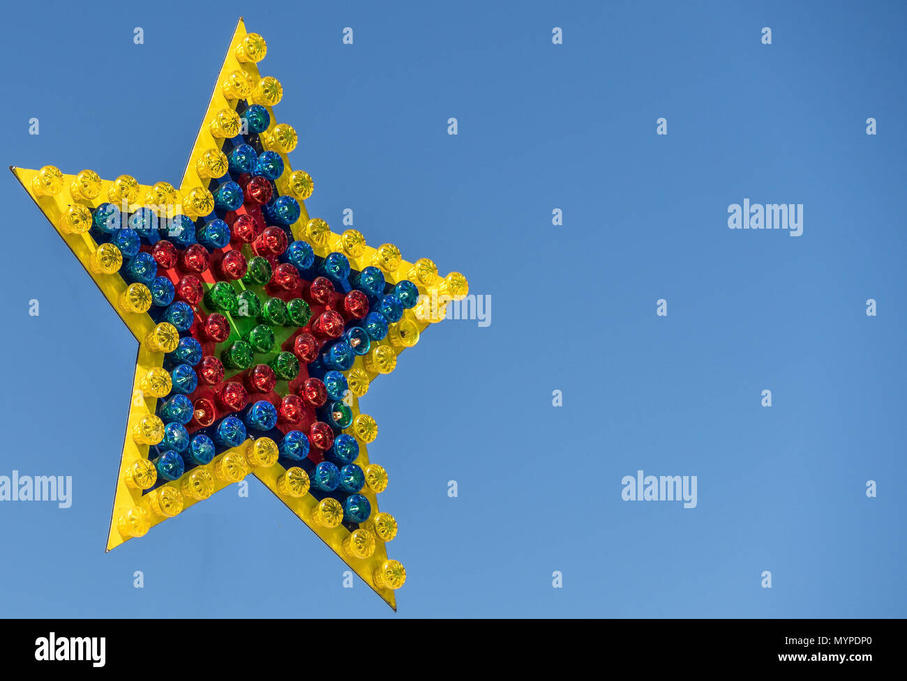 Colorful shining star from many single lamps with different colors on a ...