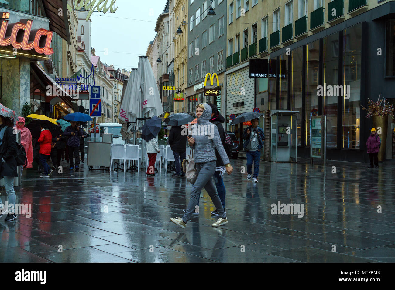 Vienna, Austria - October 22, 2017: Tourists walk in the rain in front ...