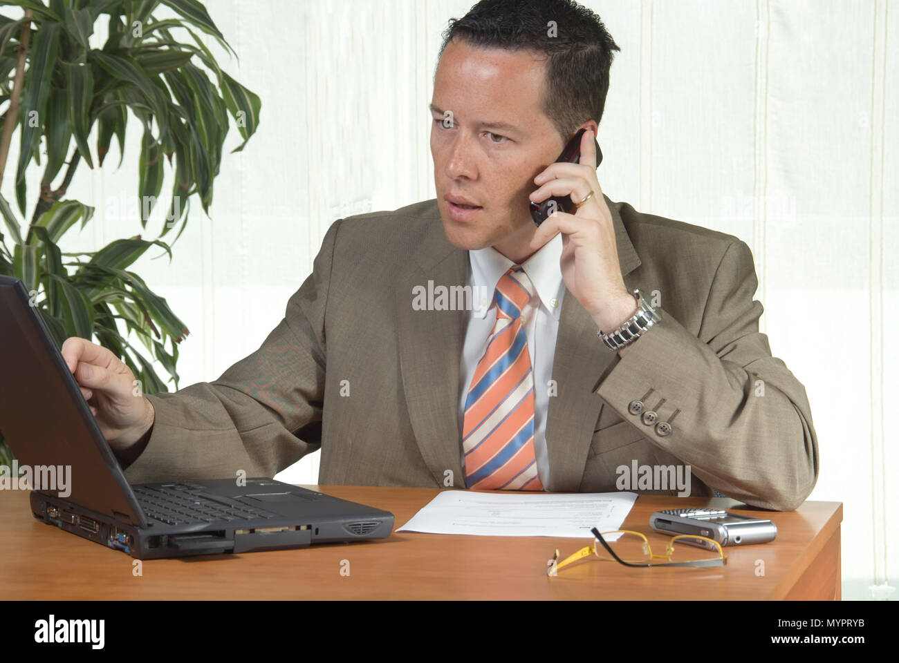 Young business man calling and pointing the laptop Stock Photo - Alamy
