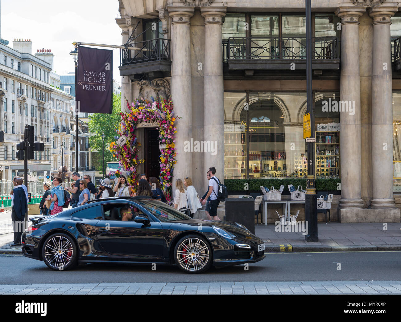 People and a Porsche 911 pass by outside the Caviar House. a seafood ...