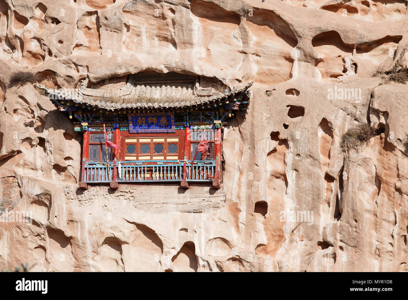 Ancient caves carved into the mountain wall hi-res stock photography ...