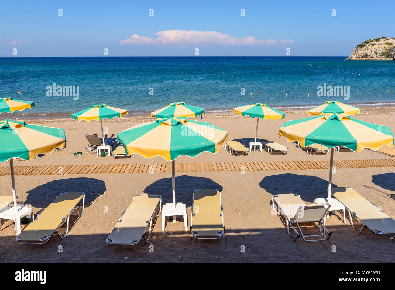 Sun loungers with umbrellas on sandy Kolymbia beach. Rhodes island ...