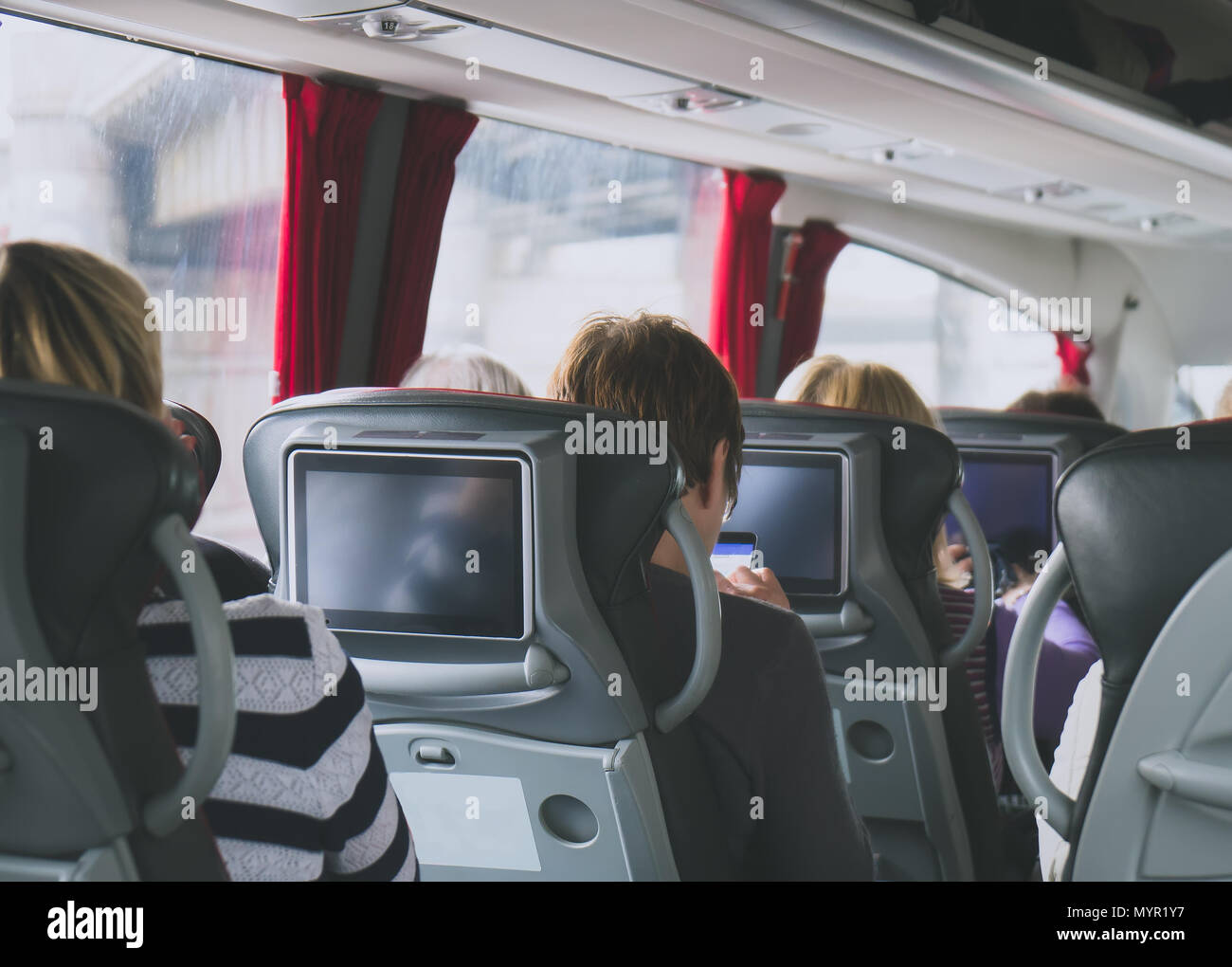 Tourist bus with passengers and built-in LCD tablets Stock Photo - Alamy