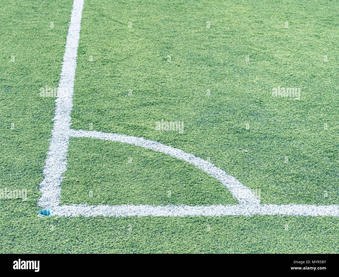 Artificial green grass with white stripe of soccer field. White line on ...