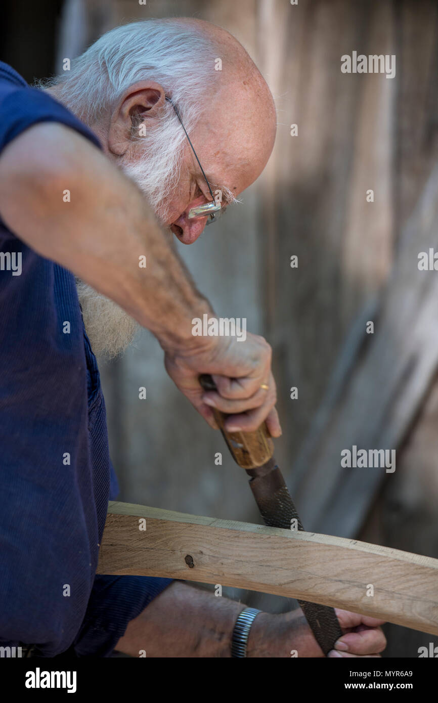 Carpenter in old fashioned clothing at work in the Open Air Museum ...