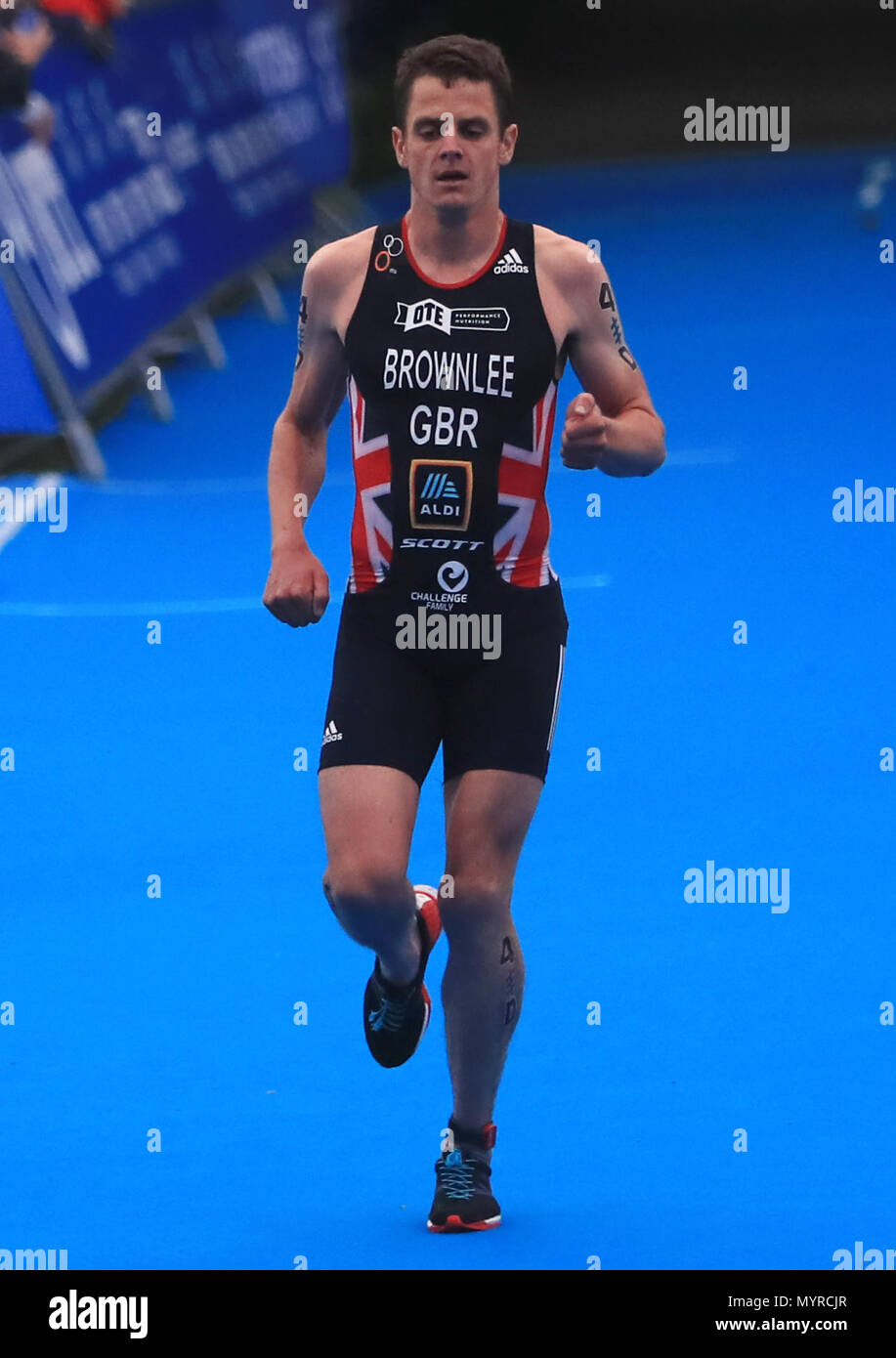 Team Great Britain's Jonathan Brownlee crosses the line to finish ...