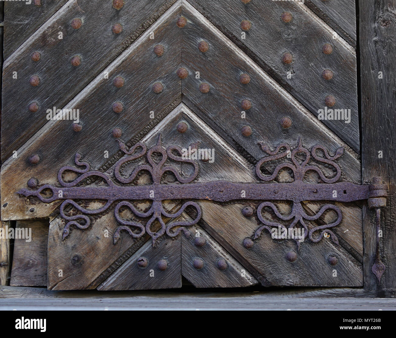original medieval riveted wooden warehouse door, carved hinge Stock ...