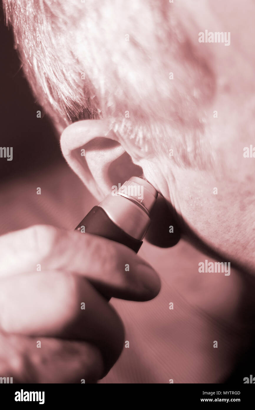 Senior citizen man cutting inner ear hair with electric cutter Stock ...