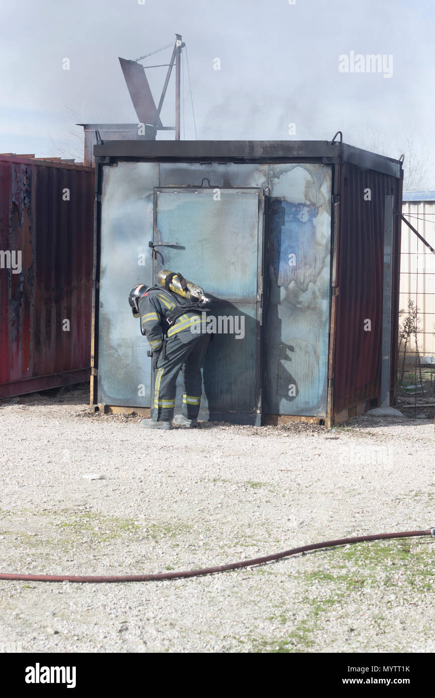Firefighter putting out fire training station extinguisher backdraft ...