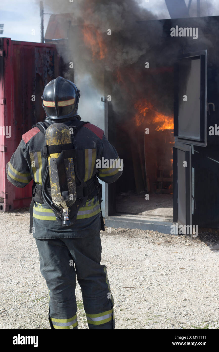 Firefighter putting out fire training station extinguisher backdraft ...