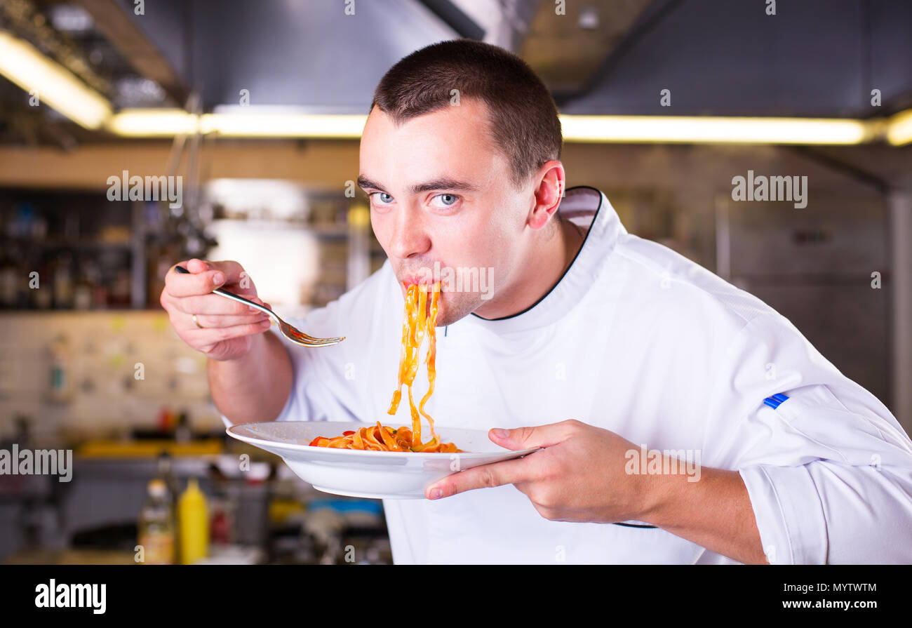 Chef is tasting the cooked dish Stock Photo - Alamy
