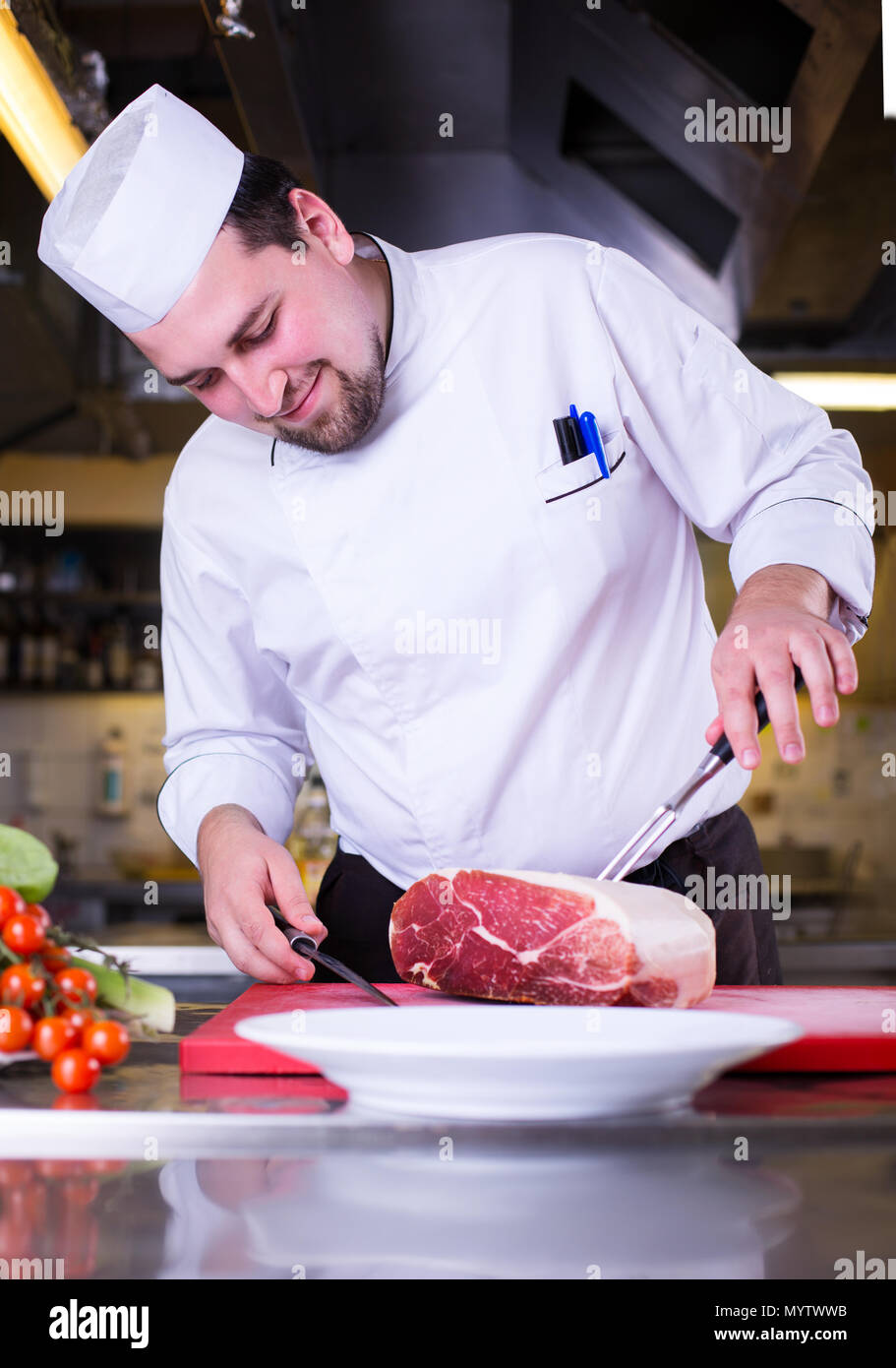 Chef cutting big piece of meat Stock Photo - Alamy