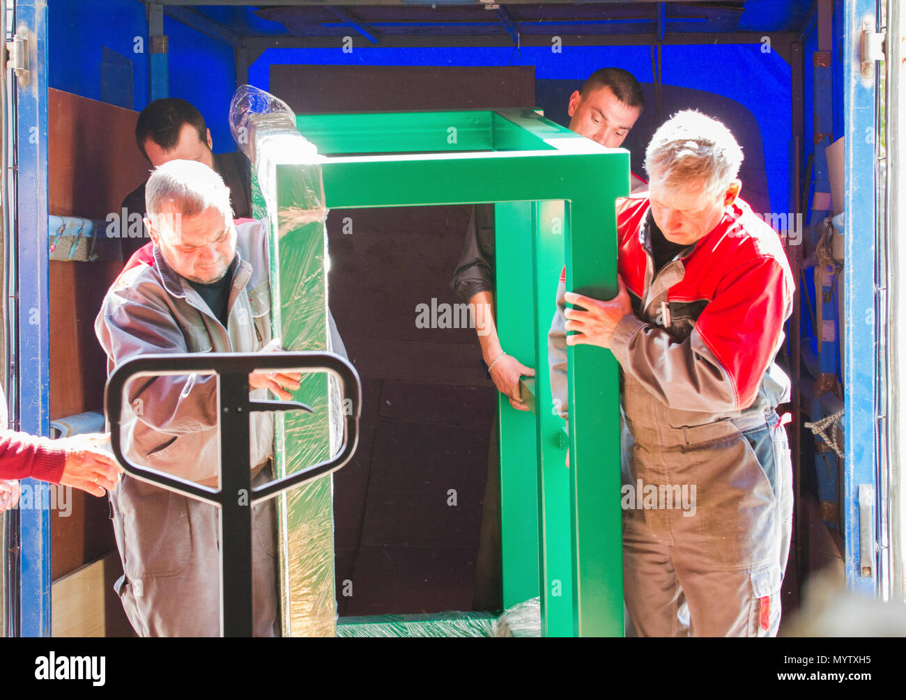 Men workers at factory production dragged the heavy object Stock Photo ...