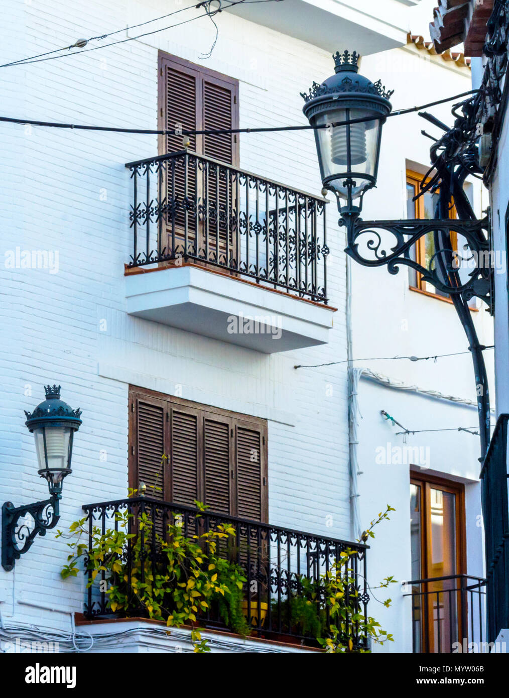 Stylish balcony with a metal railing, solid architectural element, a ...