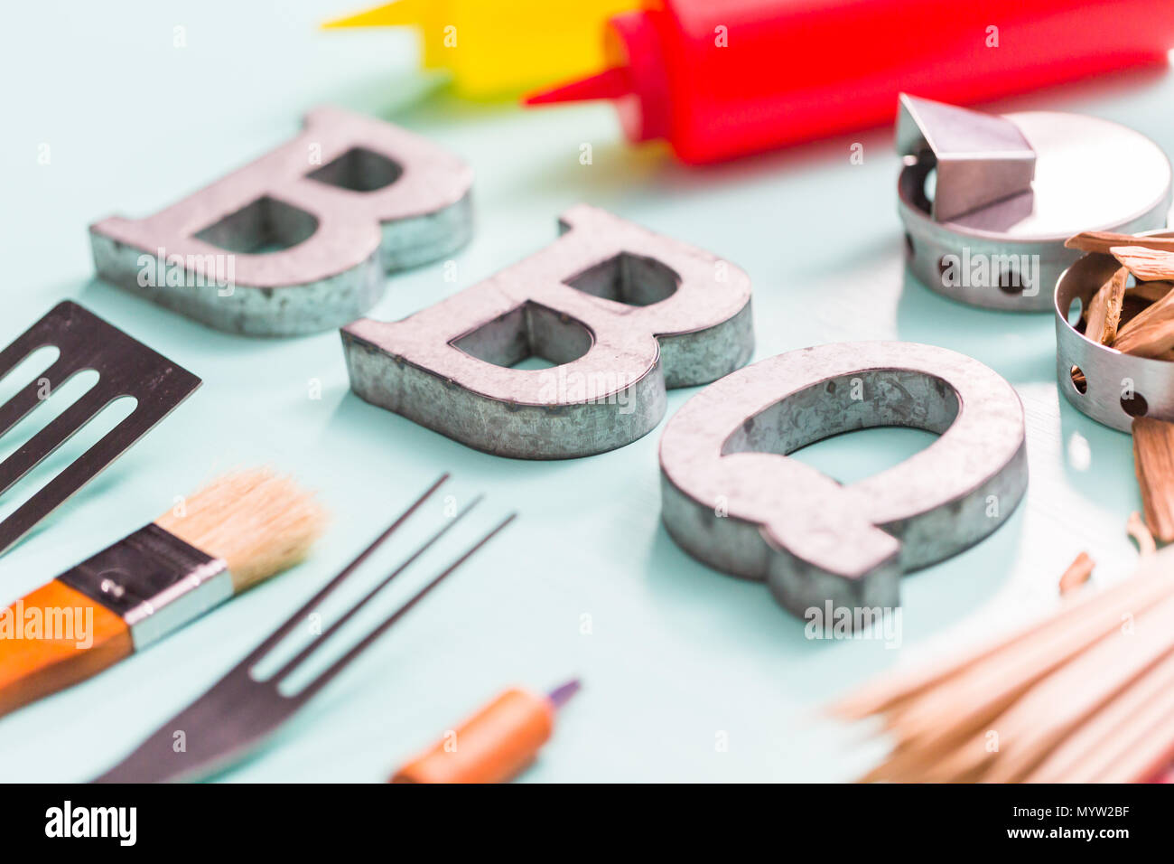 Metal BBQ sign with grilling tools Stock Photo - Alamy