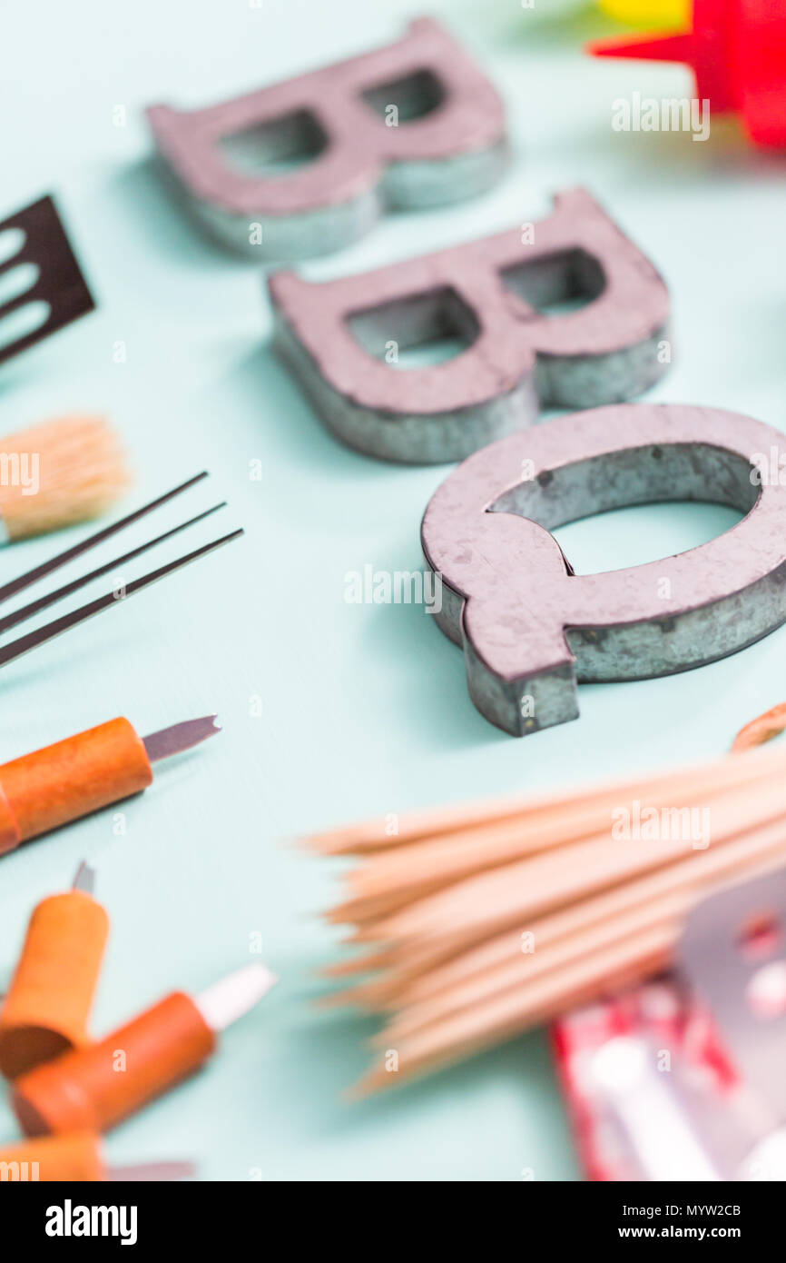 Metal BBQ sign with grilling tools Stock Photo - Alamy