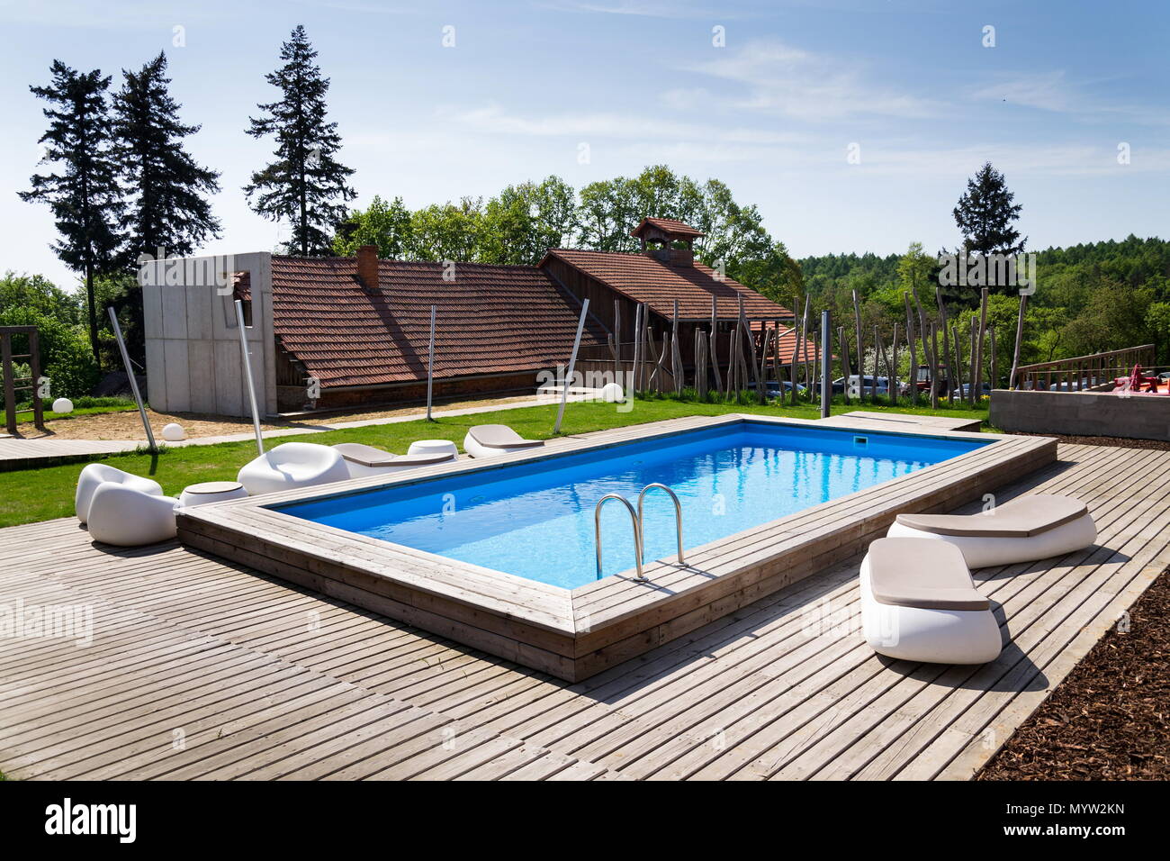 Beautiful outdoor skimmer swimming pool with wooden flooring, steel ...