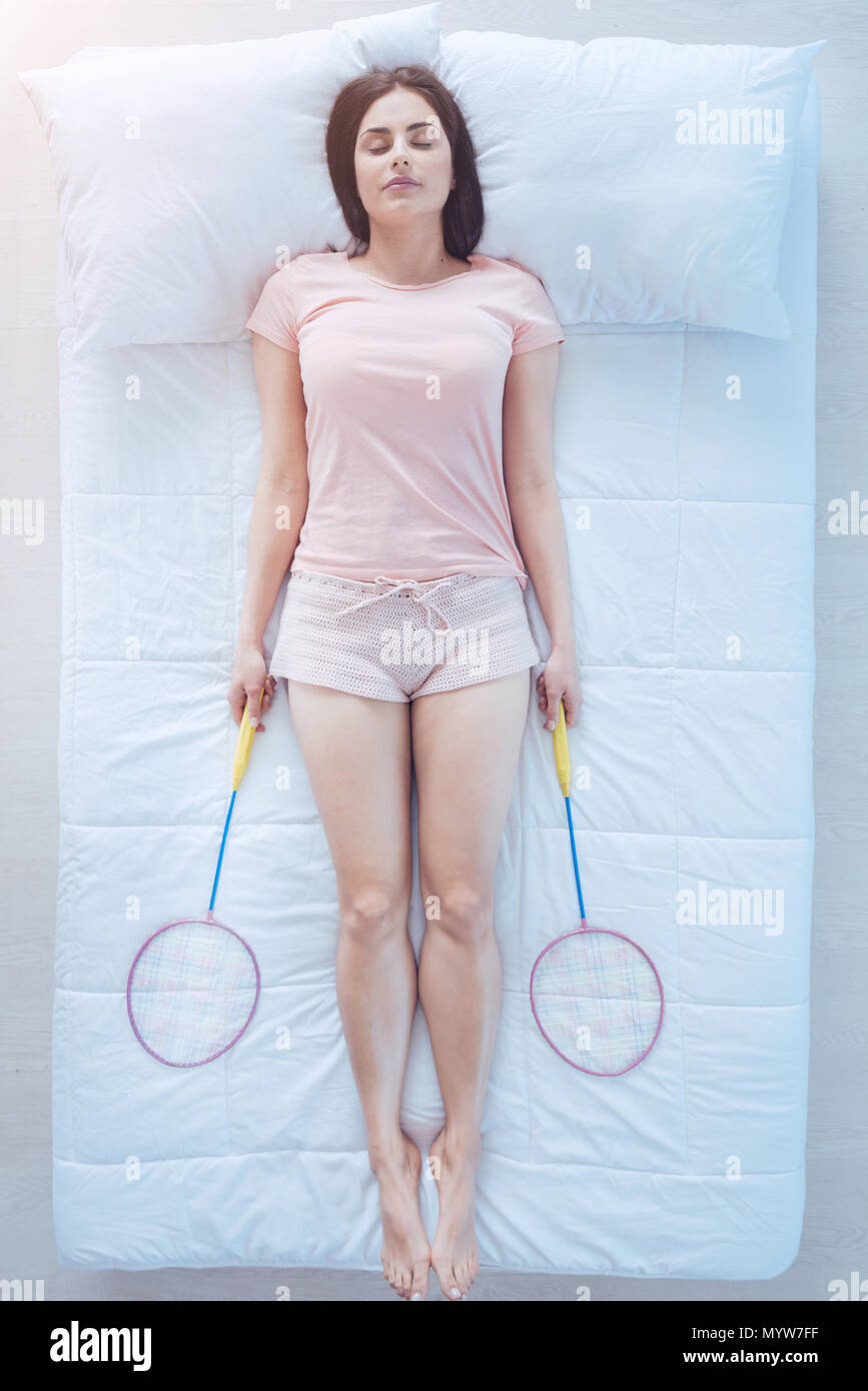 Beautiful girl with rackets sleeping in soldier position Stock Photo ...