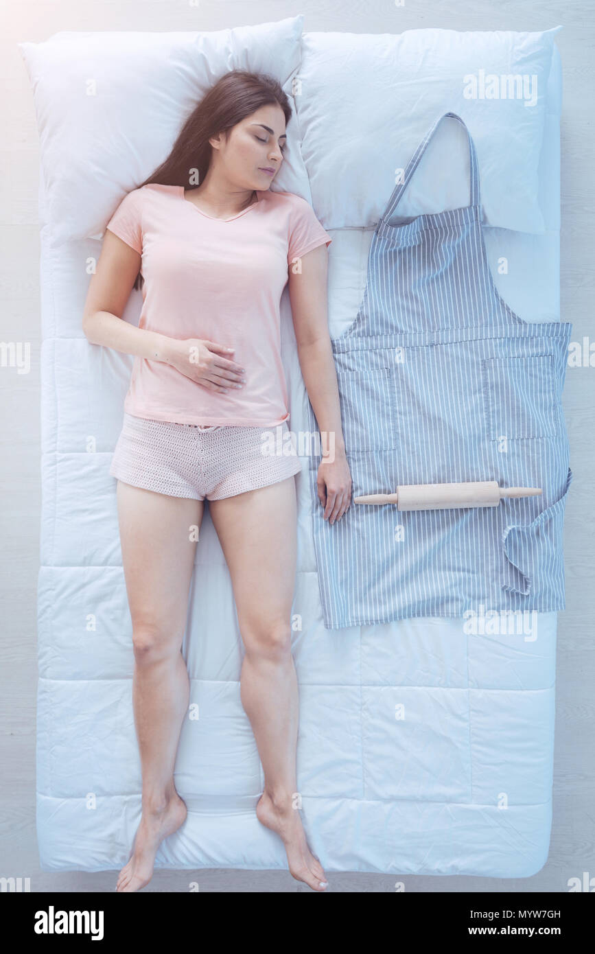 Young housewife taking nap after baking at home Stock Photo - Alamy