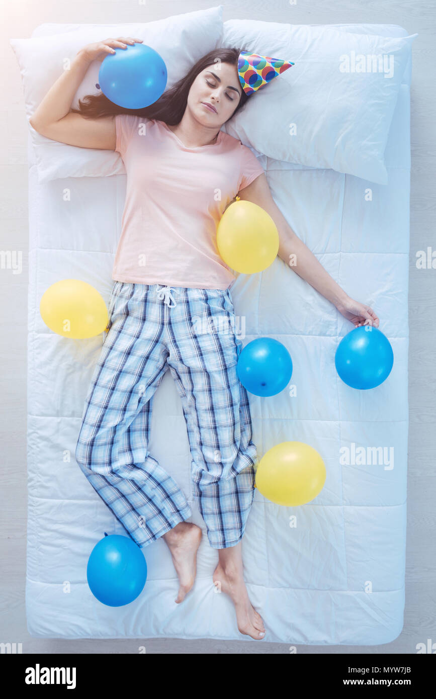 Exhausted birthday girl falling asleep in bed Stock Photo - Alamy