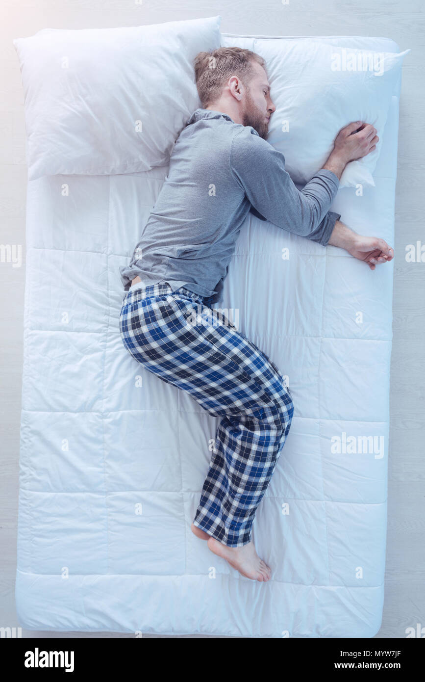 Tired millennial man falling asleep after working hard Stock Photo - Alamy