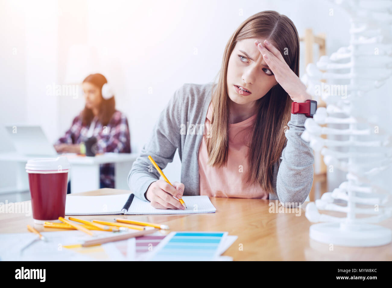 Serious female person doing task Stock Photo - Alamy