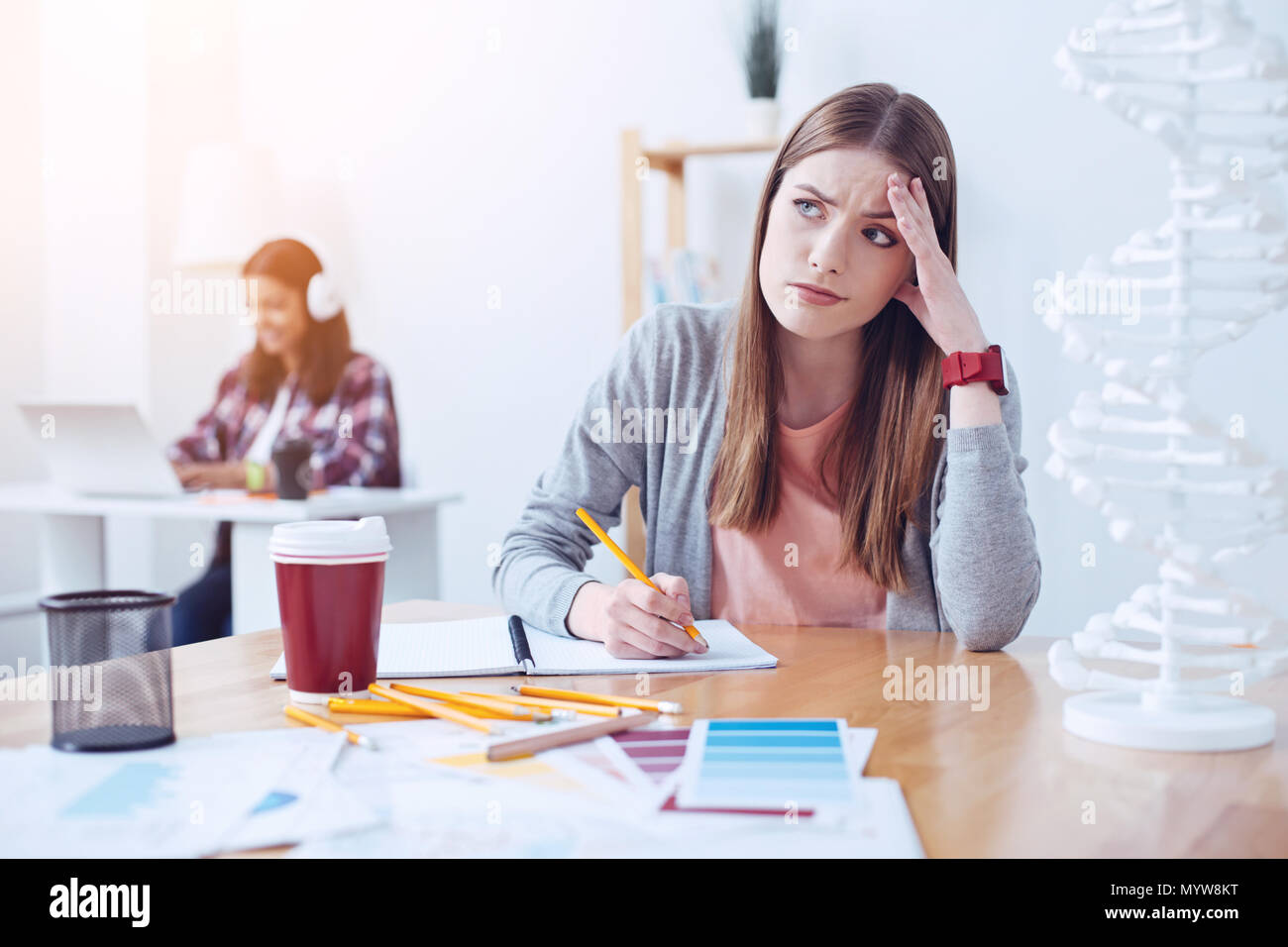 Thoughtful student waiting the ending of lesson Stock Photo - Alamy