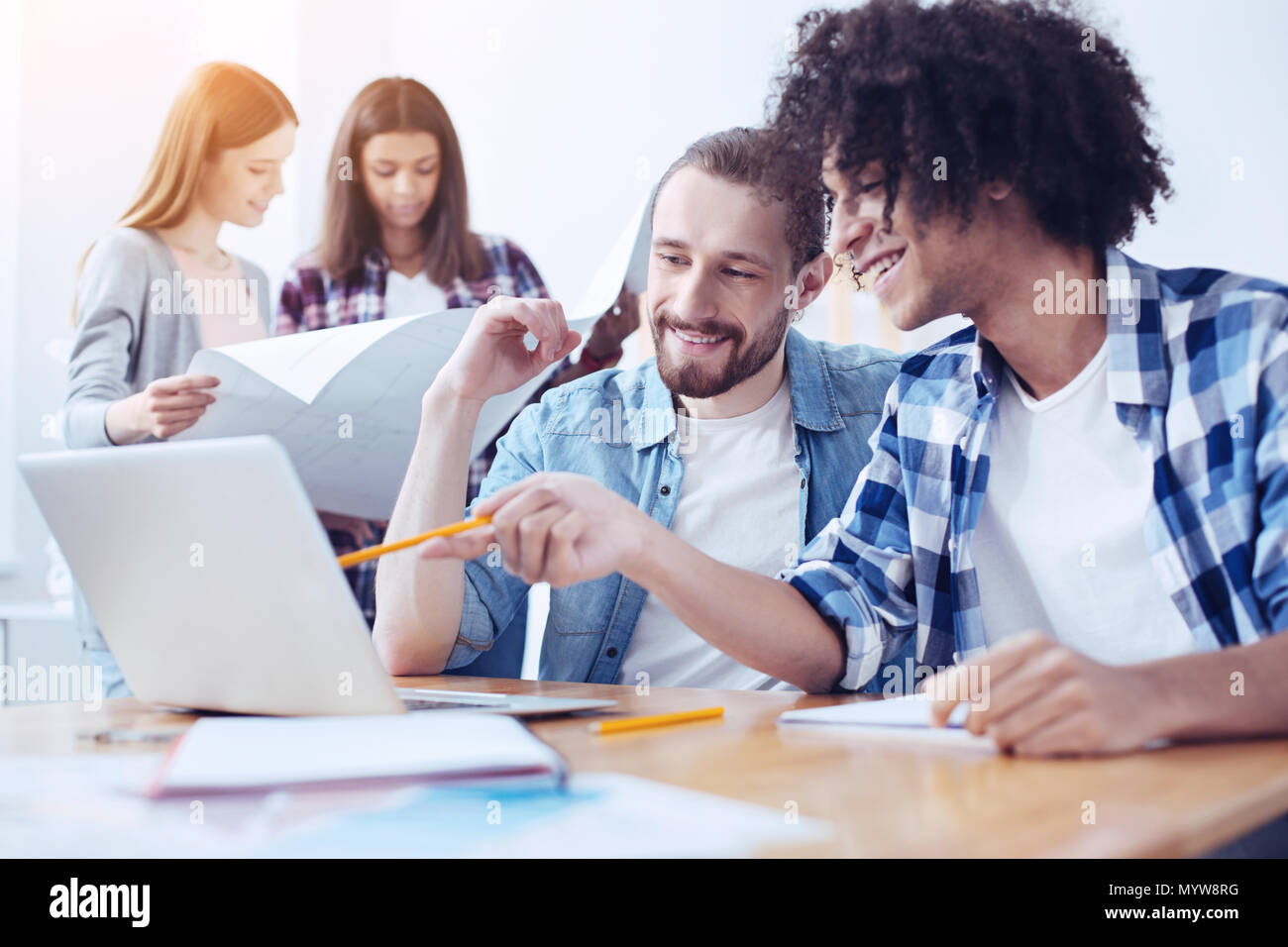 Delighted males having interesting discussion Stock Photo - Alamy