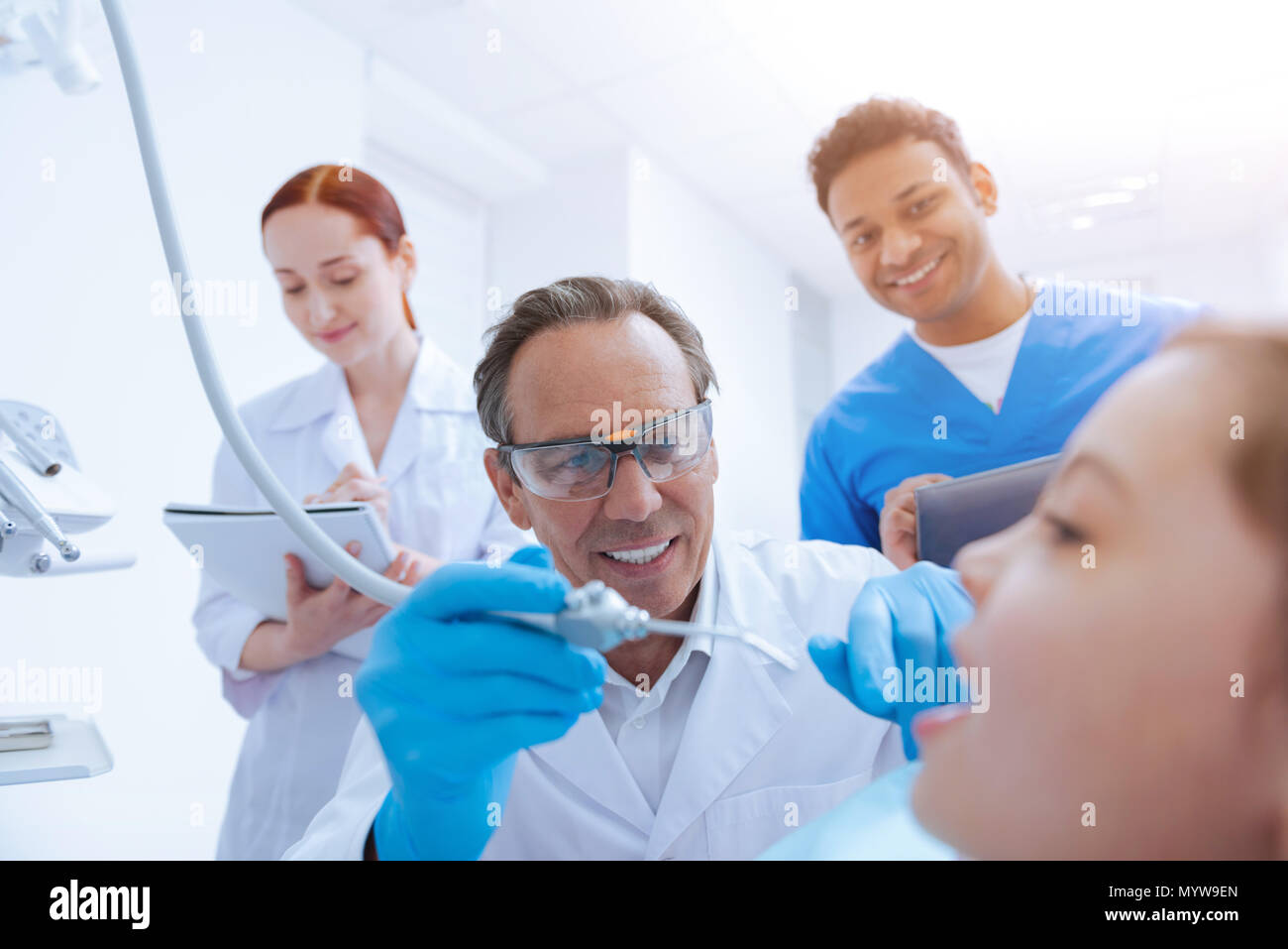 Interested in process students looking at girl Stock Photo - Alamy