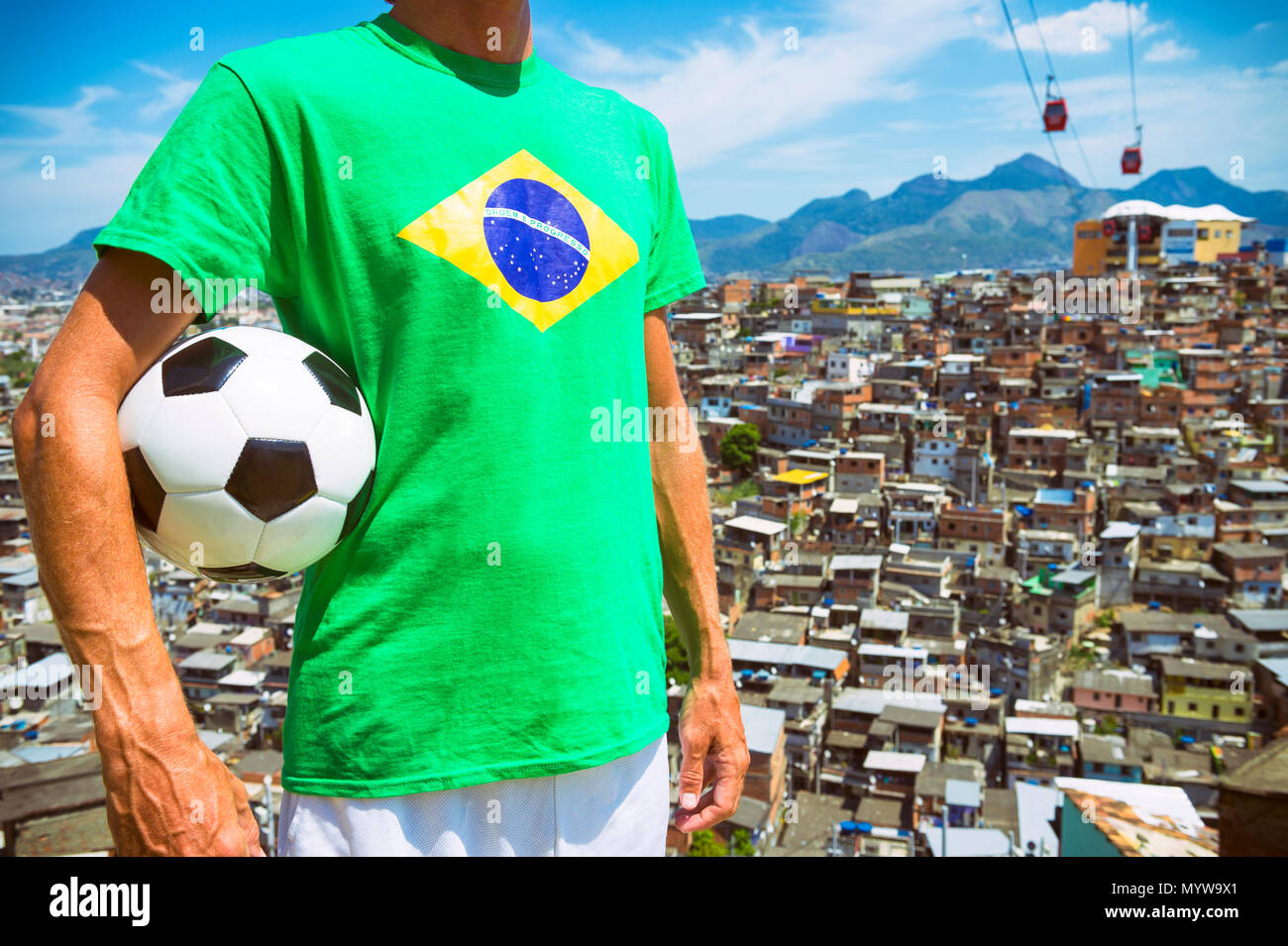 Football player standing in Brazil flag t-shirt holding soccer ball in ...