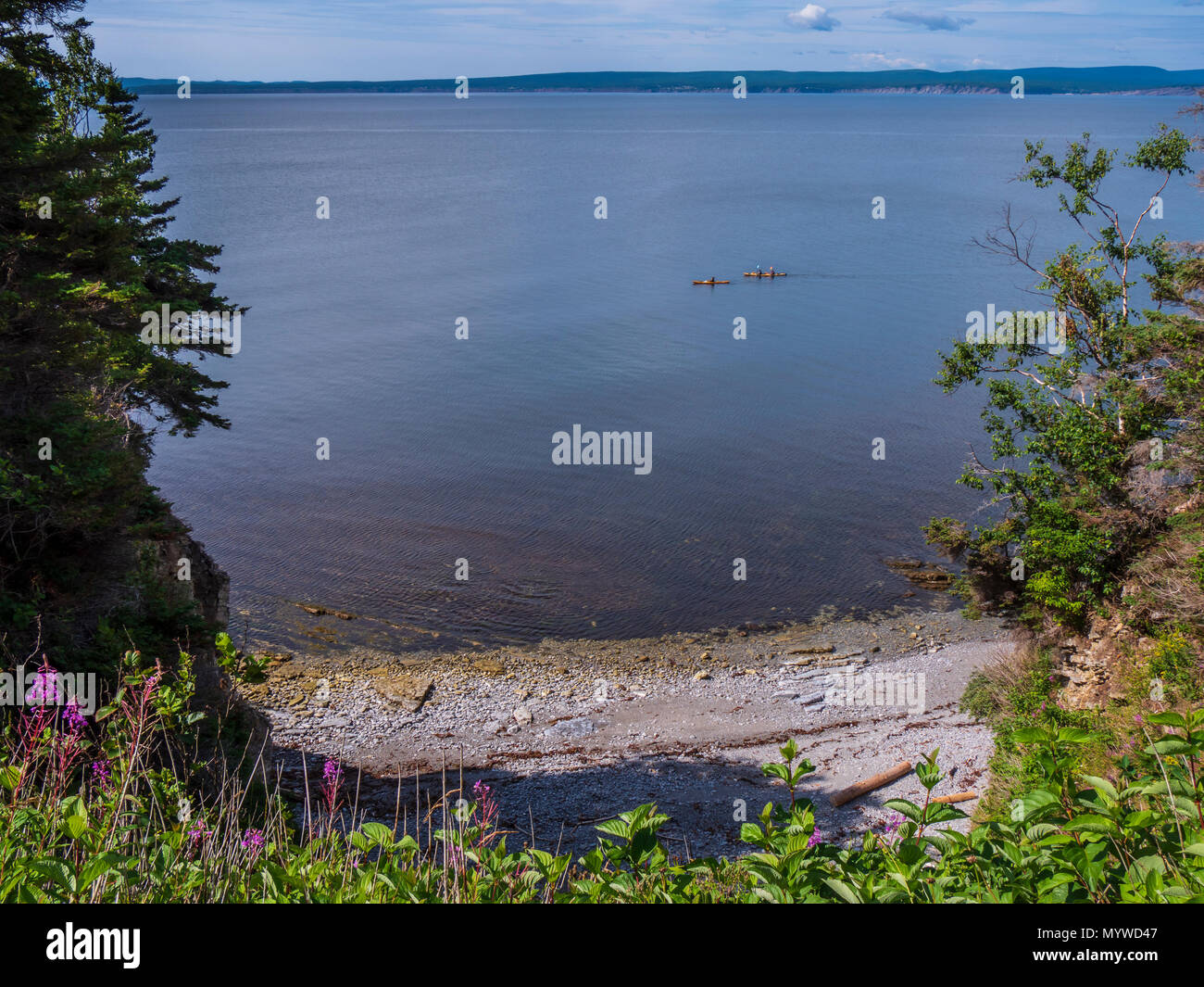 Kayakers paddle past a beach along Le Graves Trail, Forillon National ...